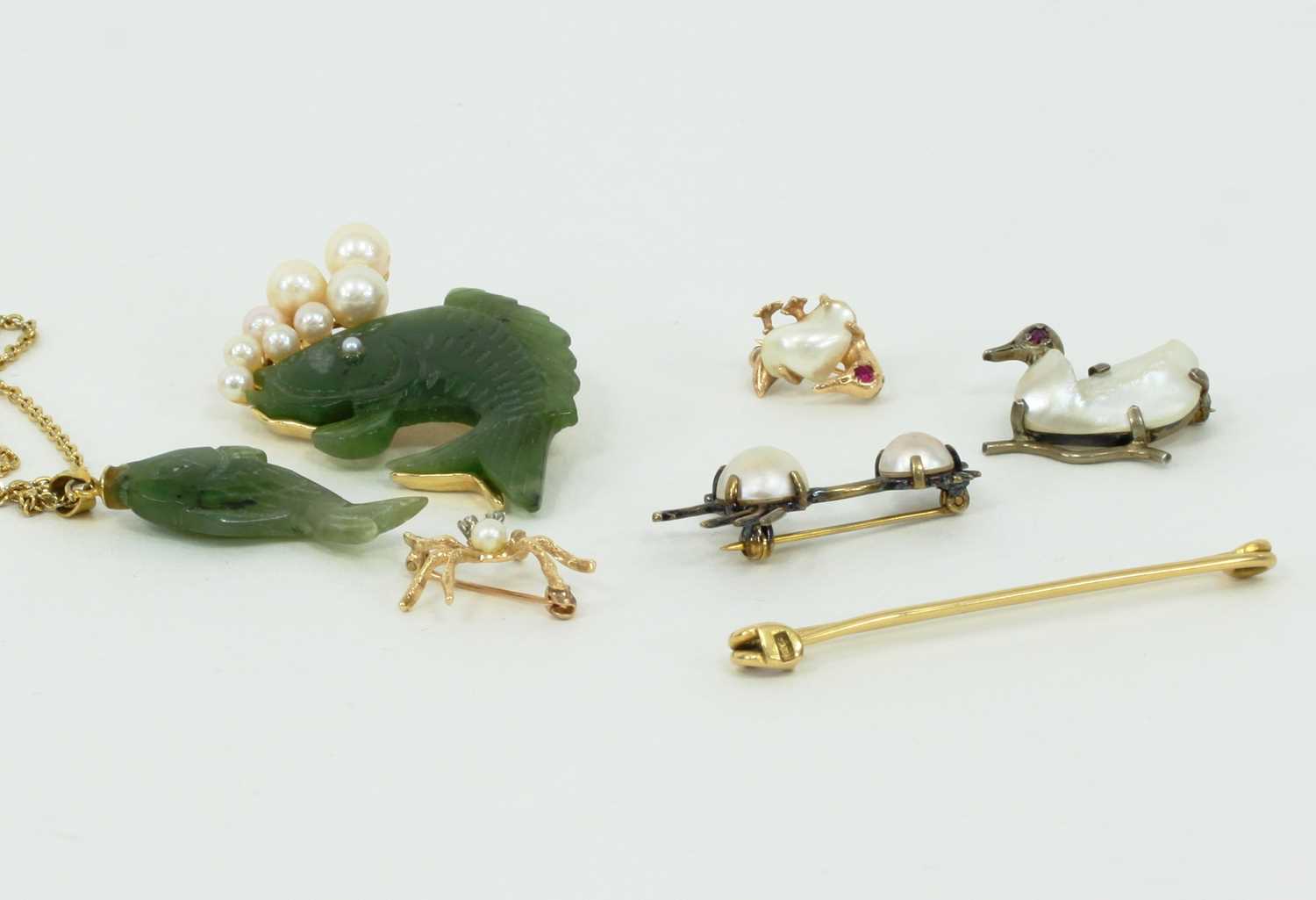 Lot 1200 - Three baroque pearl duck brooches, a jade