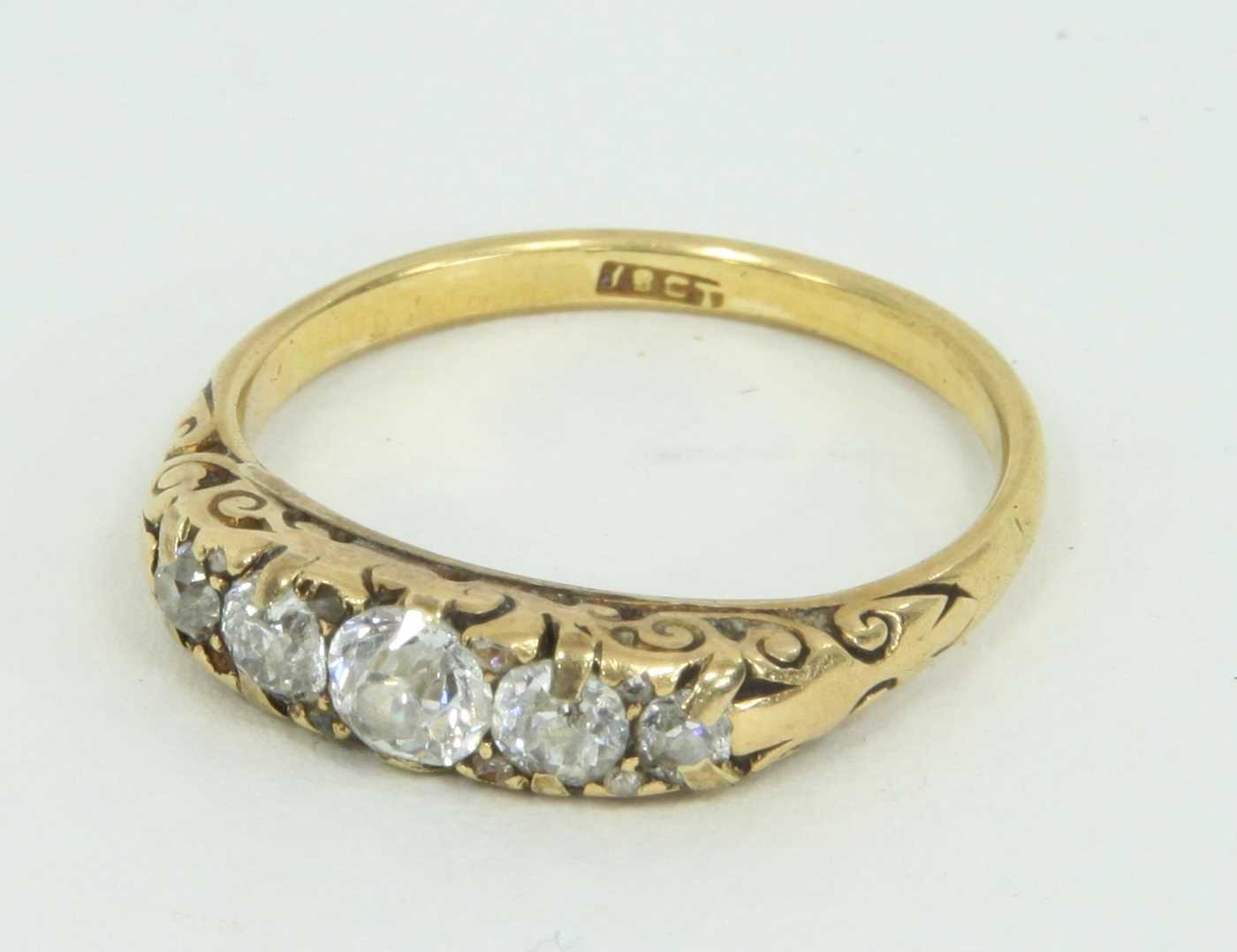 Lot 1247 - A five-stone diamond ring, the graduated