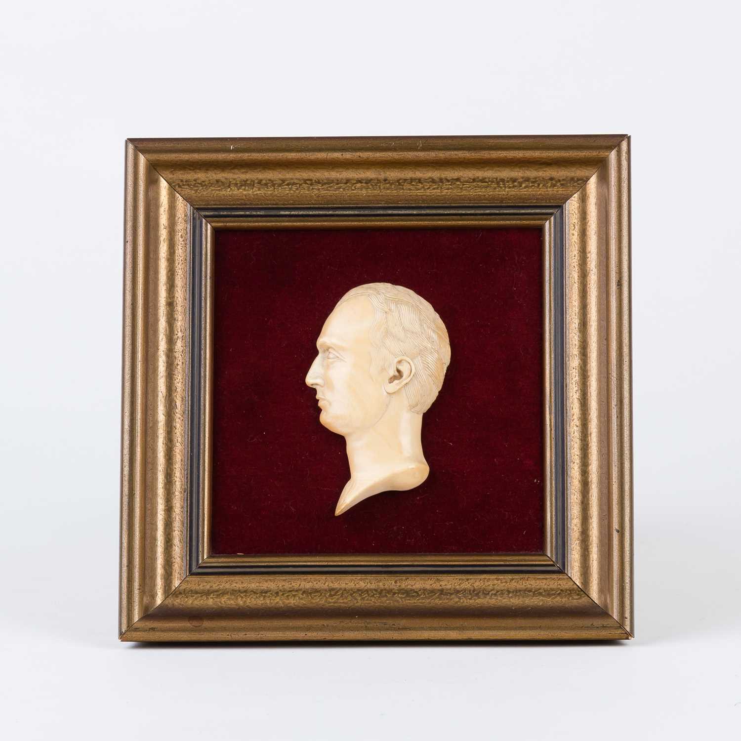 Lot 241 - An ivory relief bust of a gentleman facing