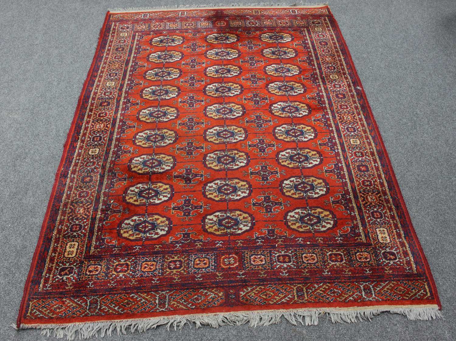 Lot 4 - An Eastern rug of Bokhara design, the red