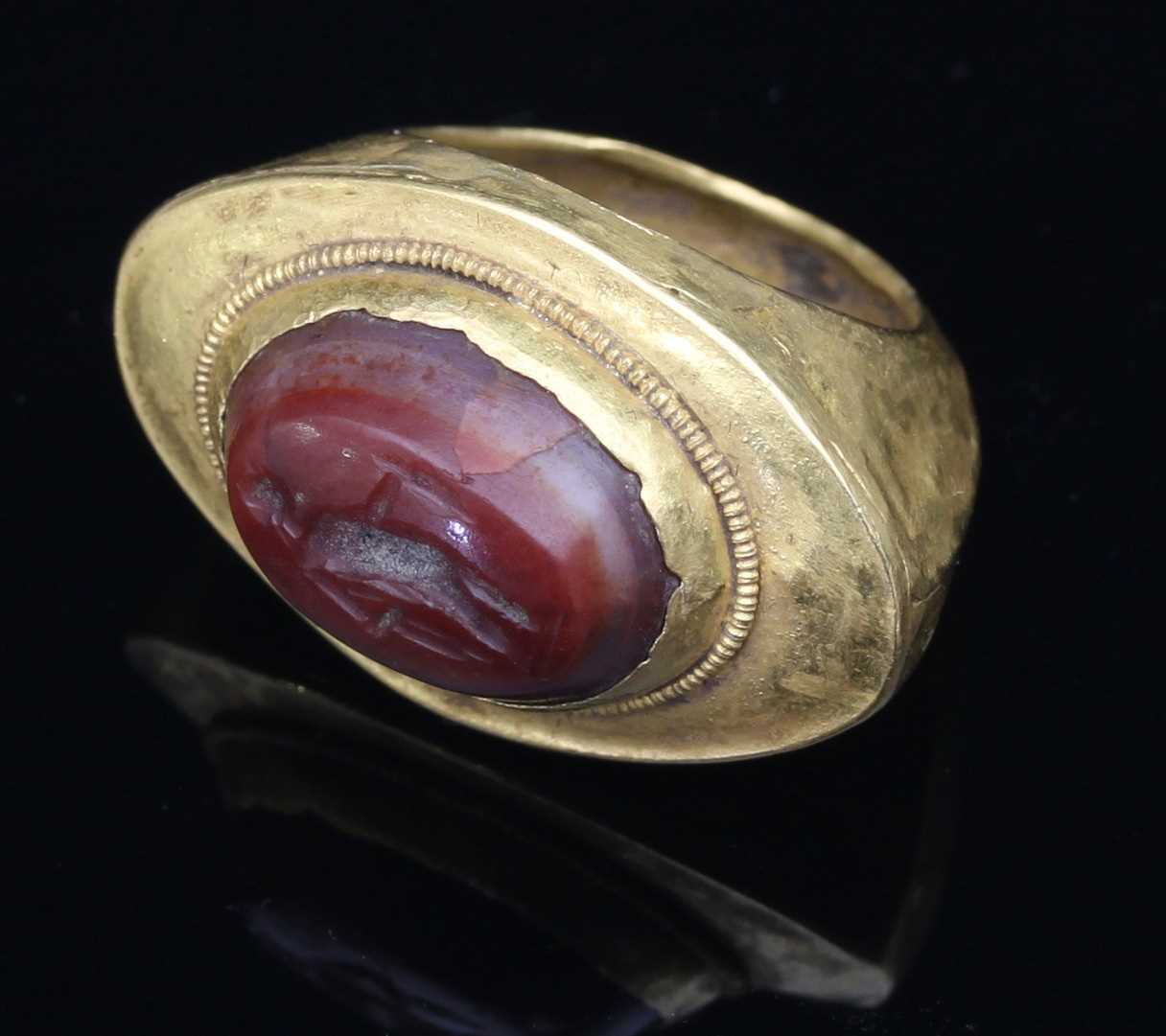 Lot 159 - An intaglio carved ring, the oval carnelian