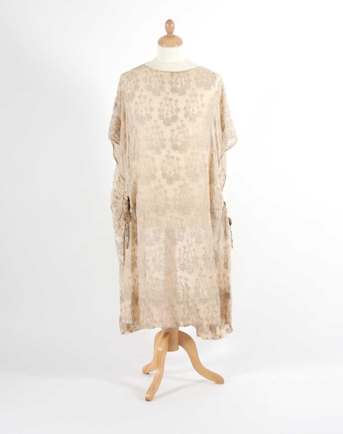 Lot 642 - A 1920s cream chiffon dress of tabard style