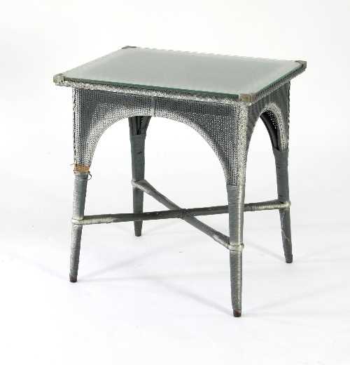 Lot 73 - A Lloyd Loom table with glass top on square