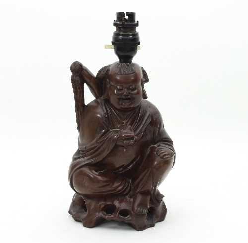 Lot 560 - A Chinese carved hardwood figure of Pu-Tai,