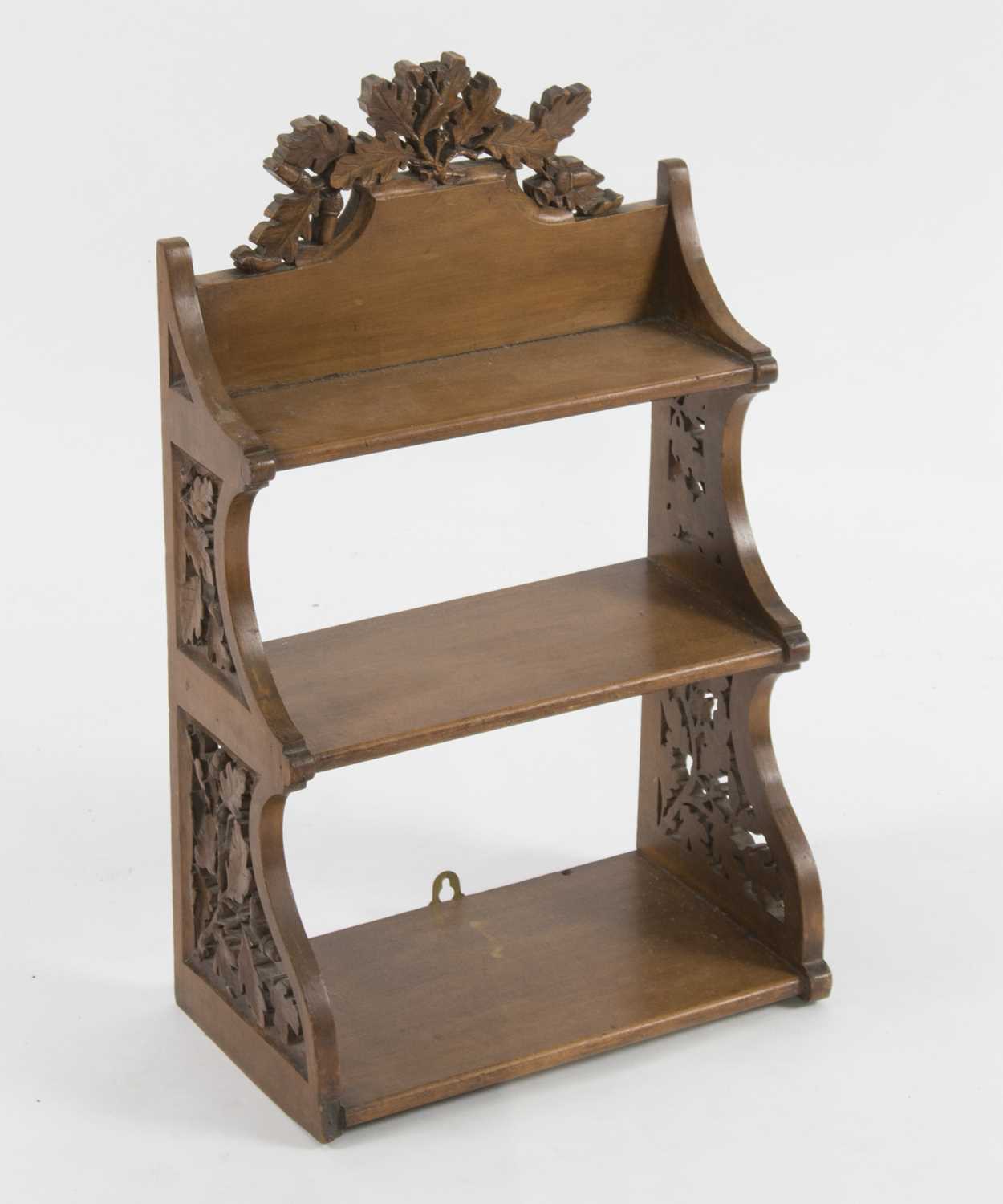 Lot 543 - A set of carved wall shelves, the crest and
