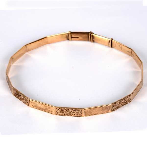 Lot 8 - A 9ct gold arm bangle, of polygonal shape with