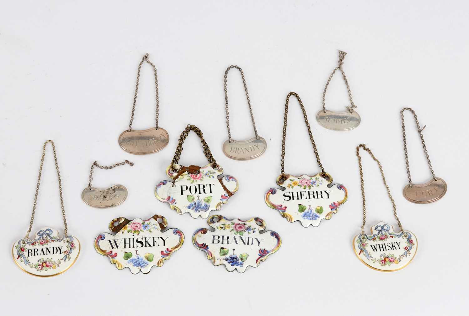 Lot 104 - A set of four enamelled decanter labels for
