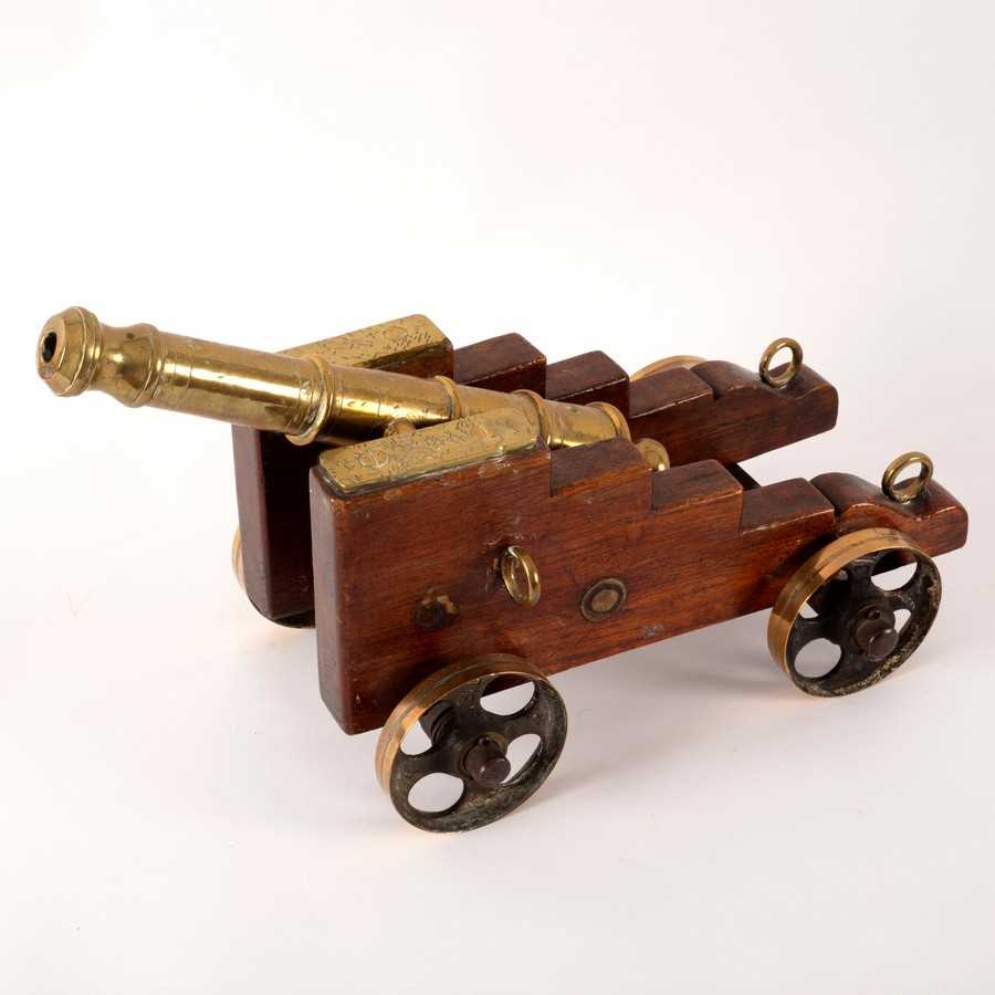 Lot 324 - A tabletop model of a brass cannon with