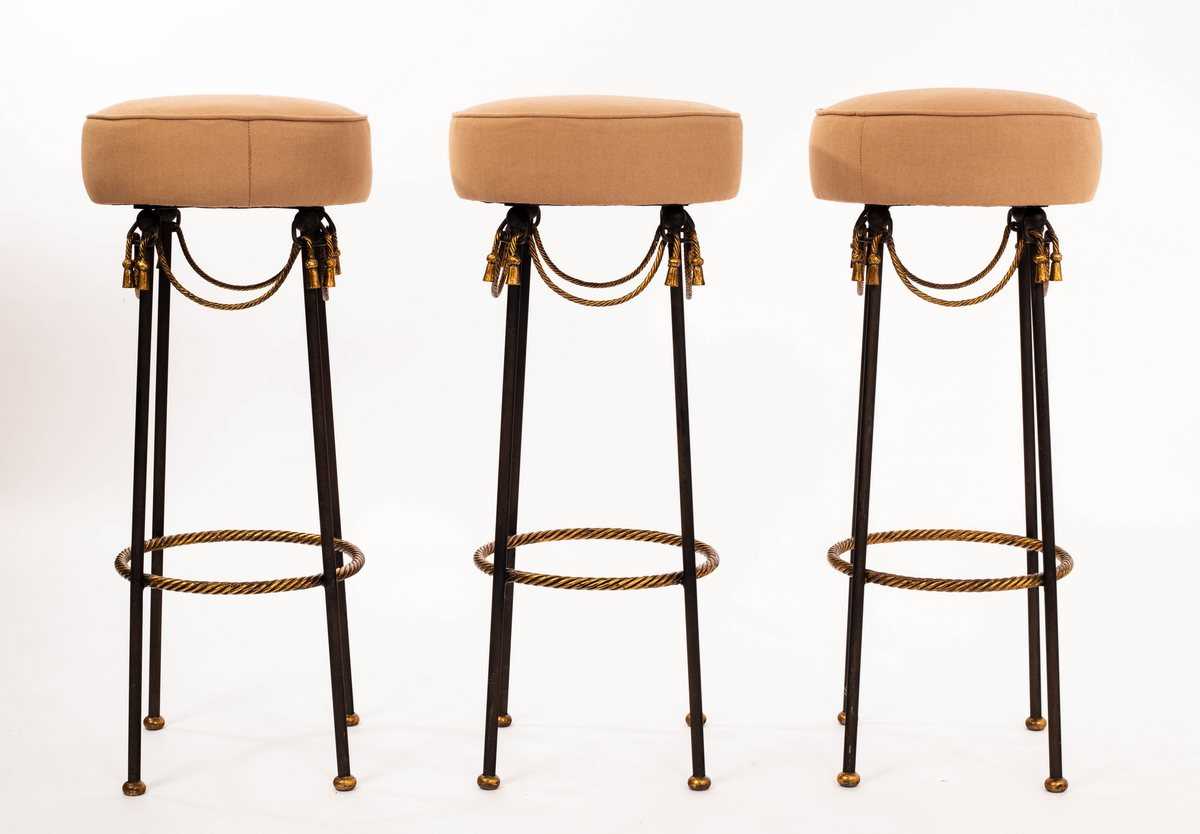 Lot 617 - Three American bar stools with upholstered