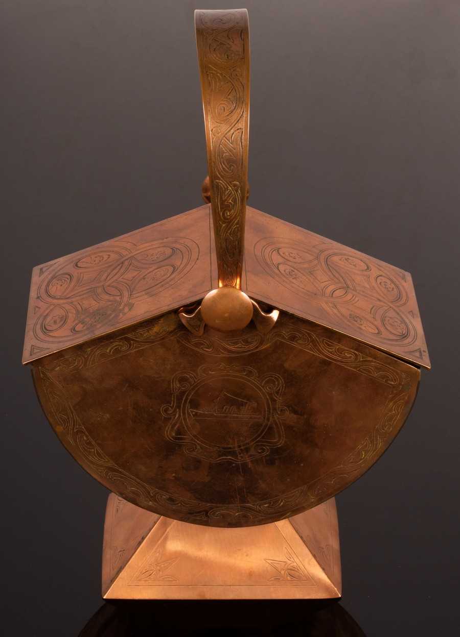 Lot 374 - A copper biscuit tin with handle and