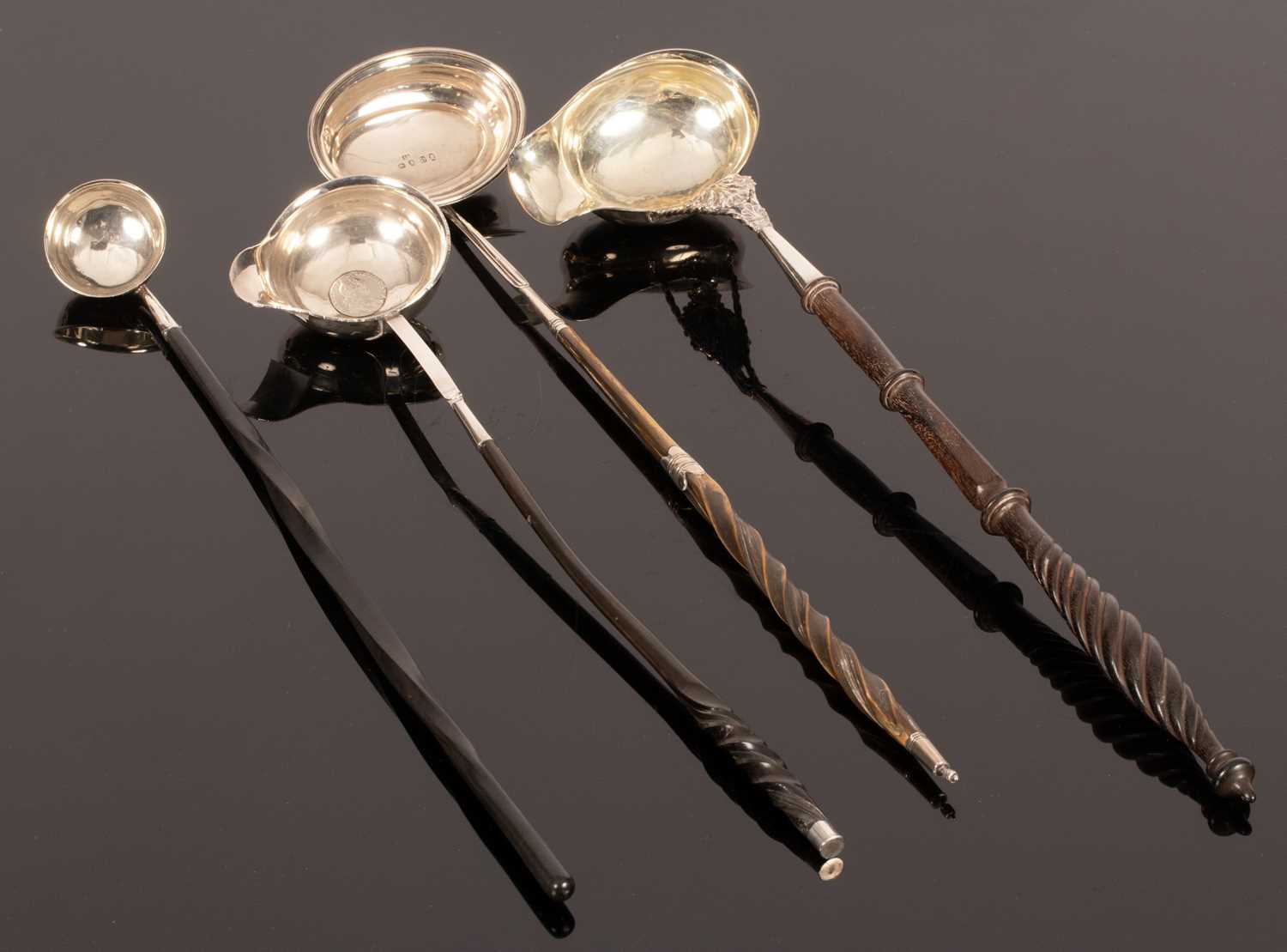 Lot 57 - Four silver toddy ladles of various sizes and