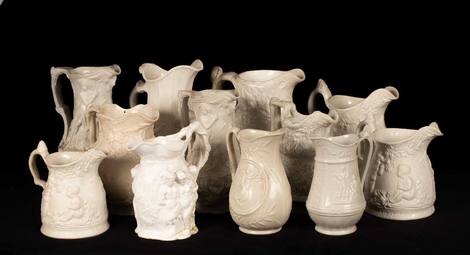 Lot 198 - Twelve saltware jugs, various patterns, the
