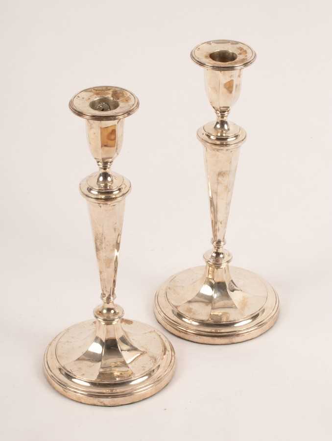 Lot 28 - A pair of Adam style silver candlesticks,