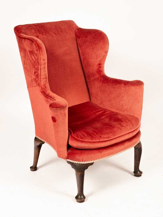 Lot 496 - A George III wingback chair on turned