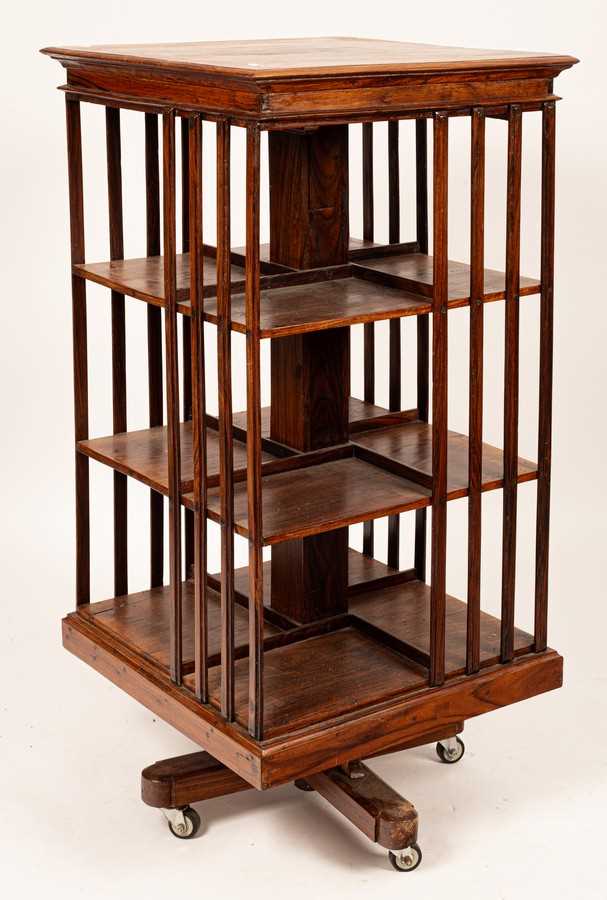 Lot 556 - A modern dark wood revolving bookcase on