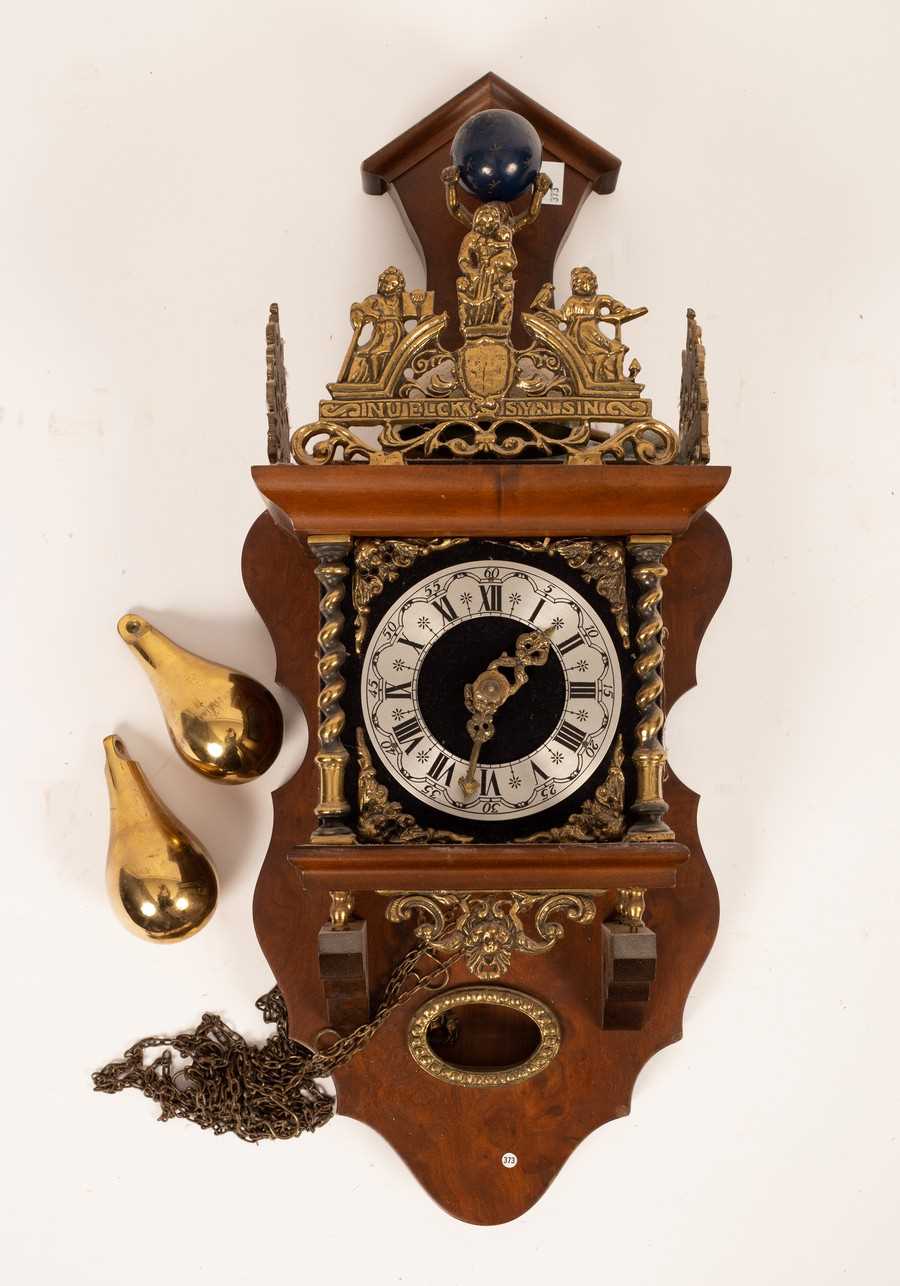 Lot 582 - A reproduction Dutch wall clock with brass