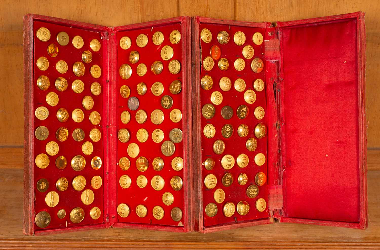 Lot 521 - A tailor’s folding case of hunt buttons